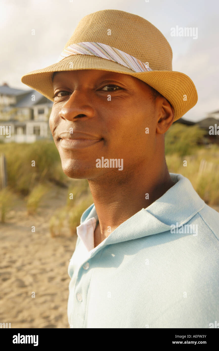 Close up of African man in hat at beach Stock Photo - Alamy