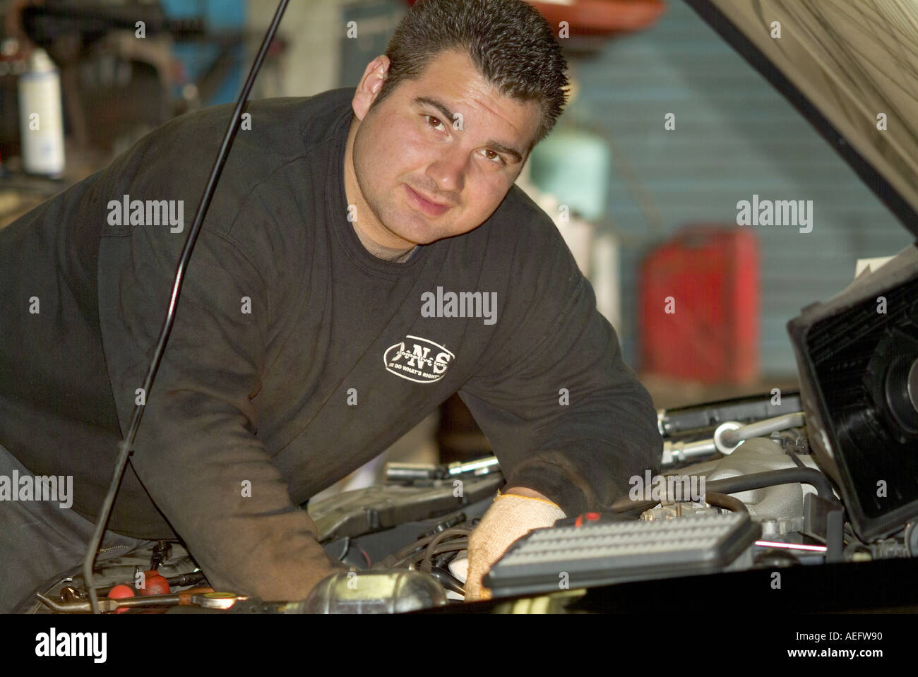 Mechanic working on engine Stock Photo - Alamy