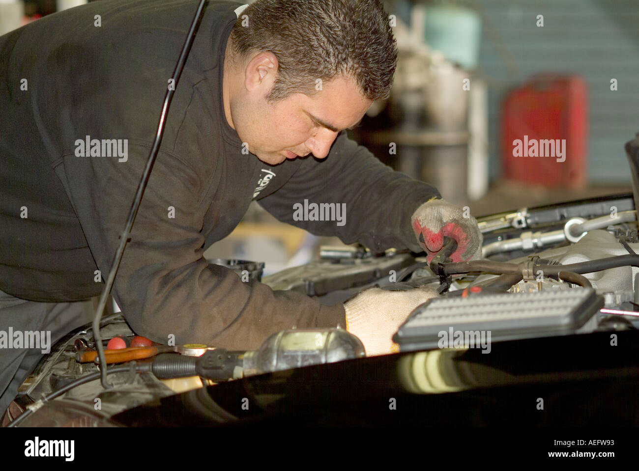 Mechanic working on engine Stock Photo - Alamy