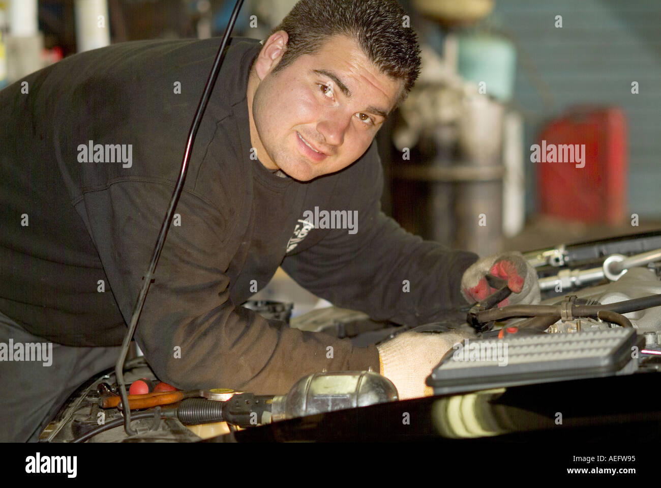 Mechanic working on engine Stock Photo - Alamy