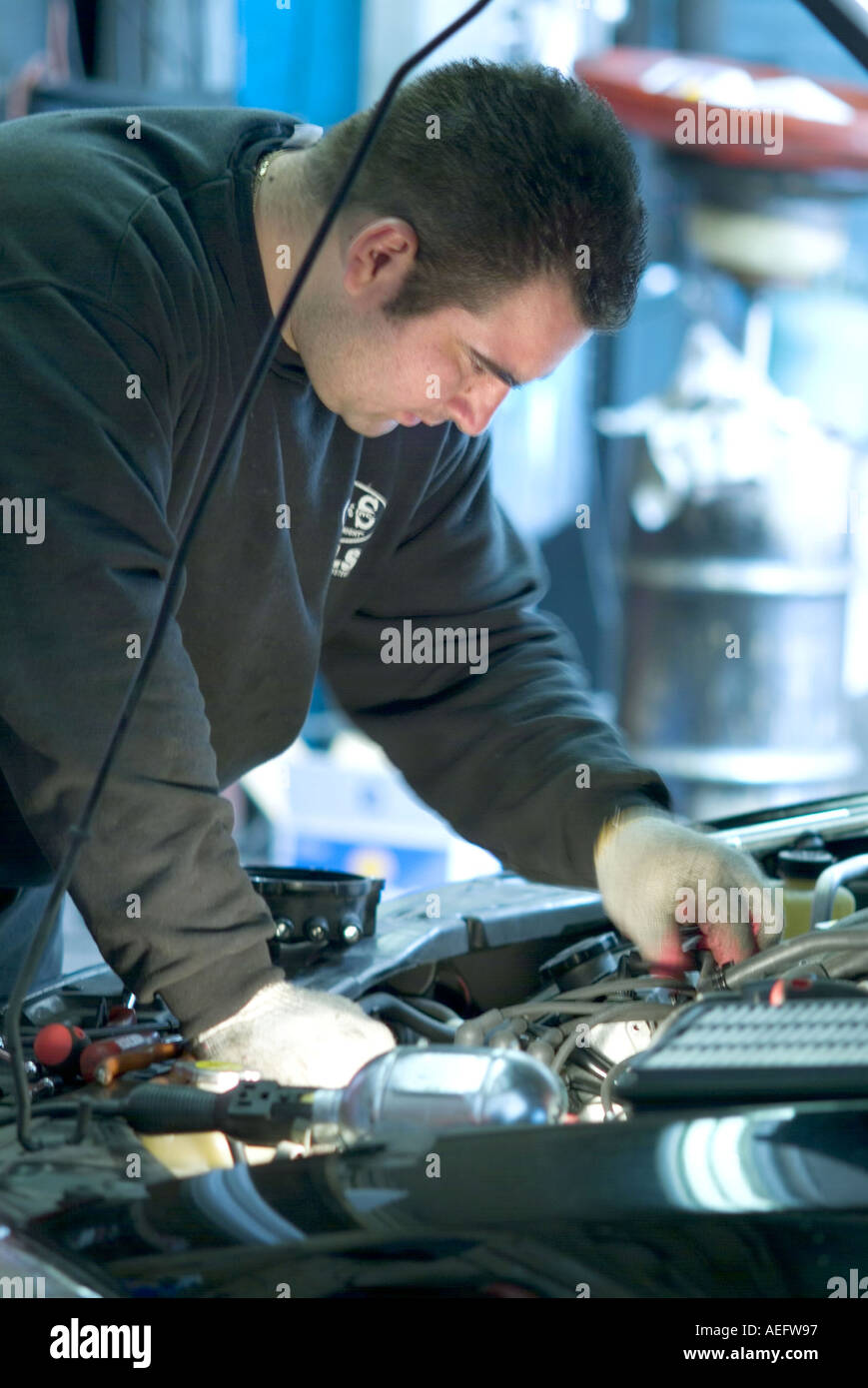 Mechanic working on engine Stock Photo - Alamy