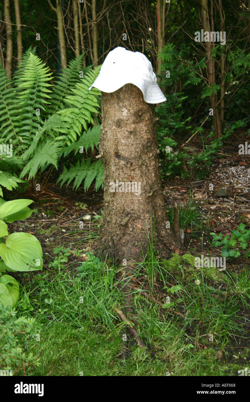 little tree man with a white hat in garden surroundings Stock Photo - Alamy