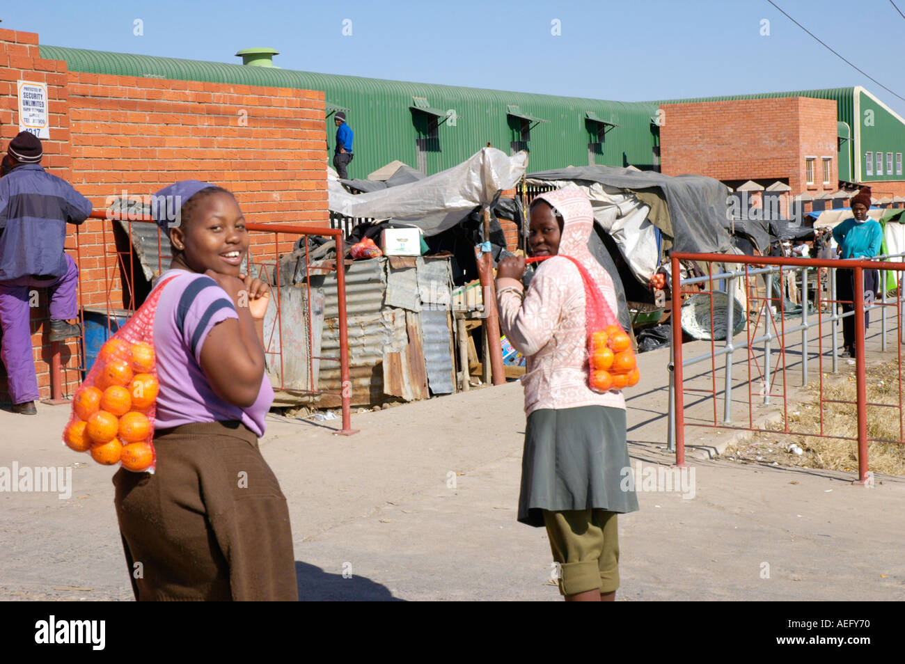 Two black women selling outside a Chinese clothing factory for making ...
