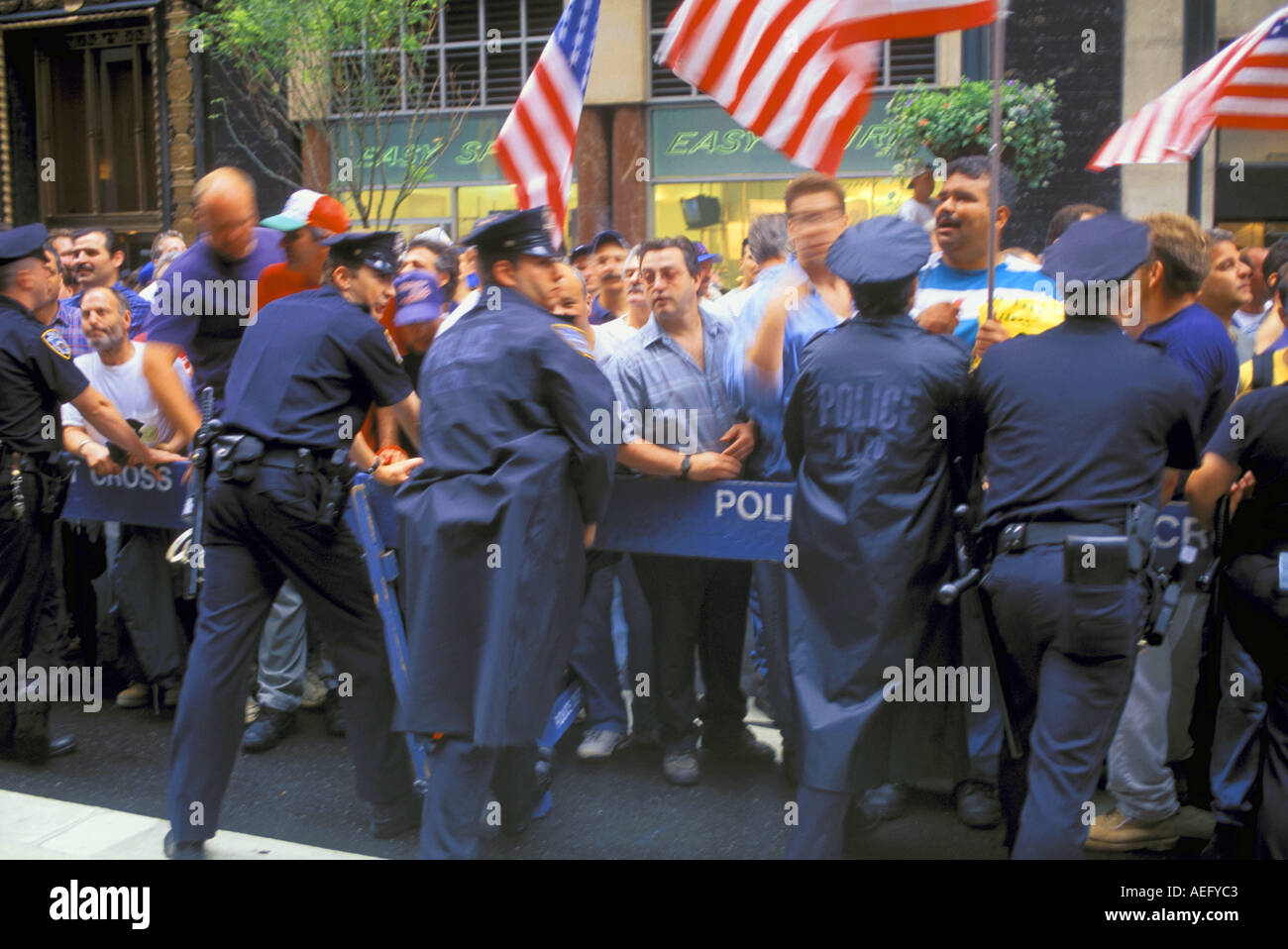 NYC Police barricades holding back crowd Stock Photo - Alamy