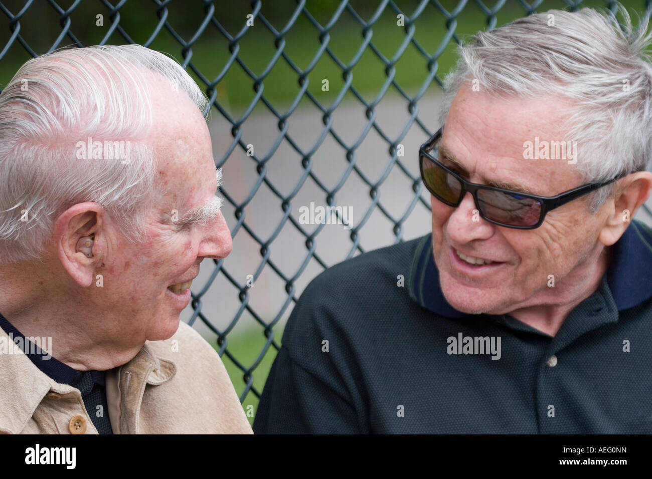 Two elderly men having a conversation smiling and sharing a laugh Stock ...