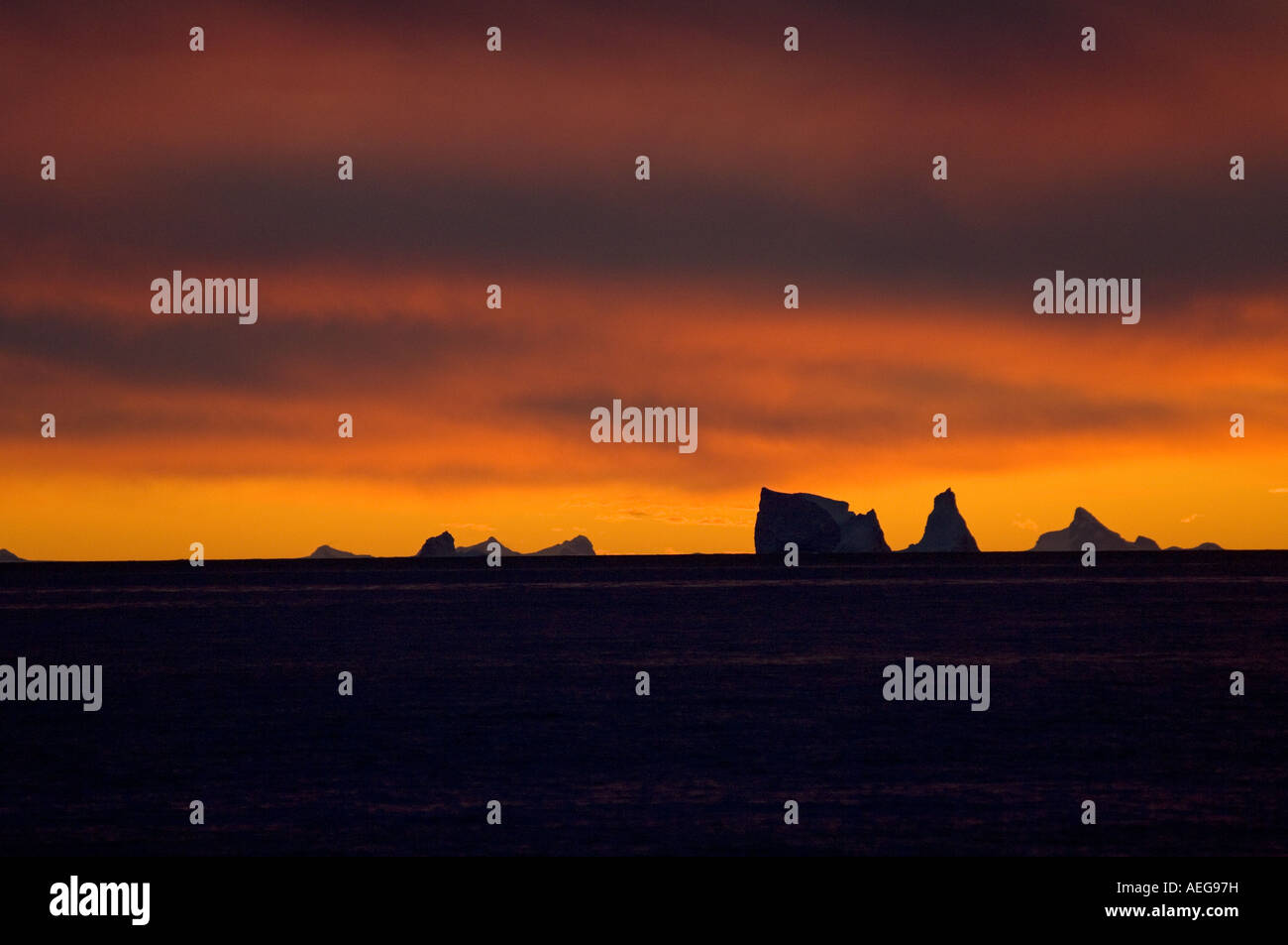 iceberg silhouette at sunset off the western Antarctic peninsula ...