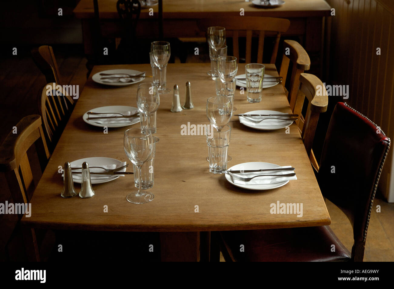 Dinner table, plain wood with place setting Stock Photo - Alamy