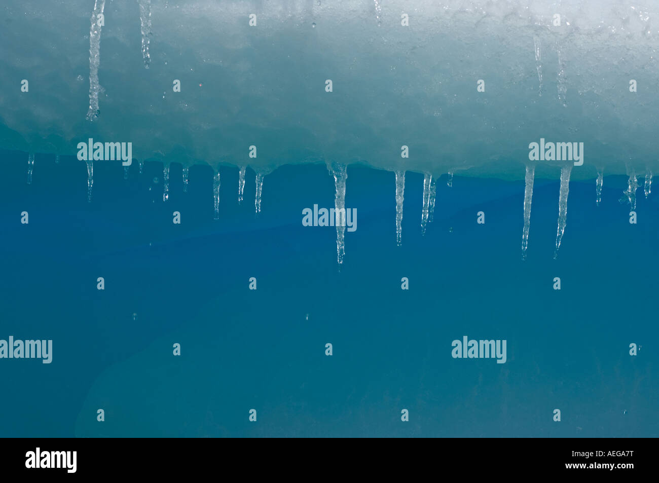 water dripping from icicles hanging along an iceberg western Antarctic ...
