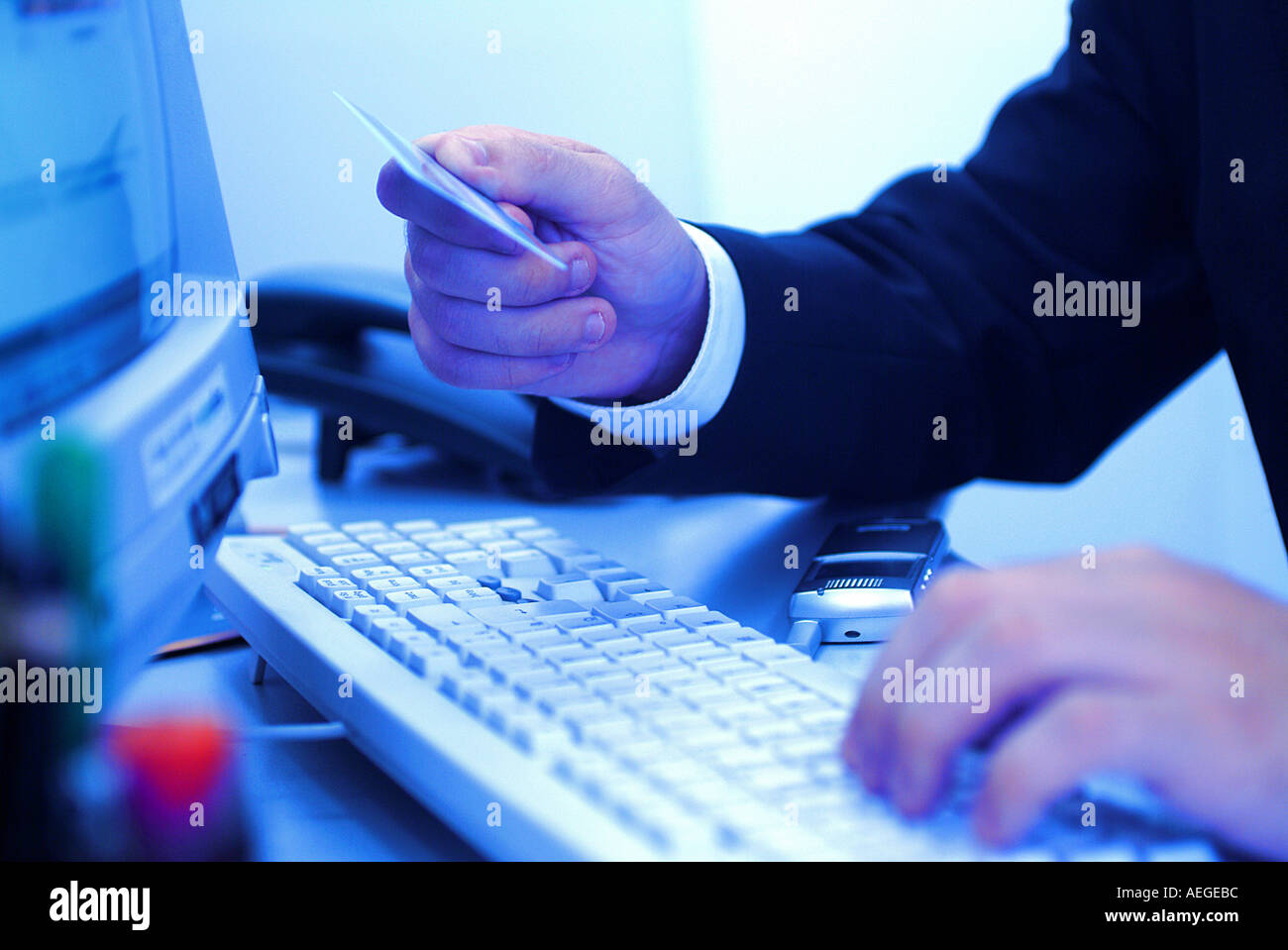 Businessman office keyboard screen monitor typing phone desk desktop ...