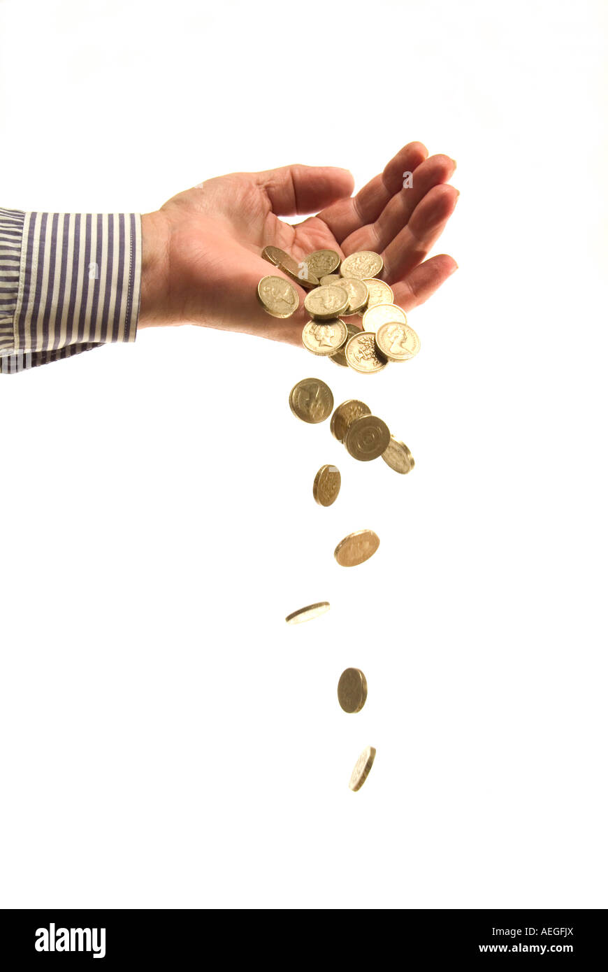 Pound coins falling from hand Stock Photo - Alamy