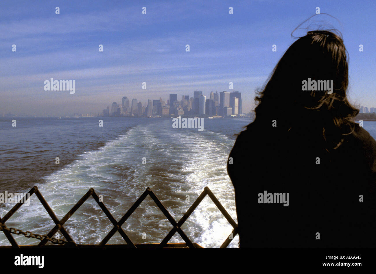 NYC woman looking back at view from ferry Stock Photo - Alamy