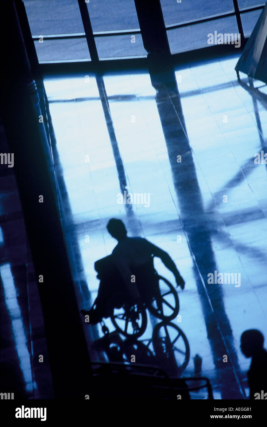 Disabled businessman on wheelchair exiting building with briefcase on ...