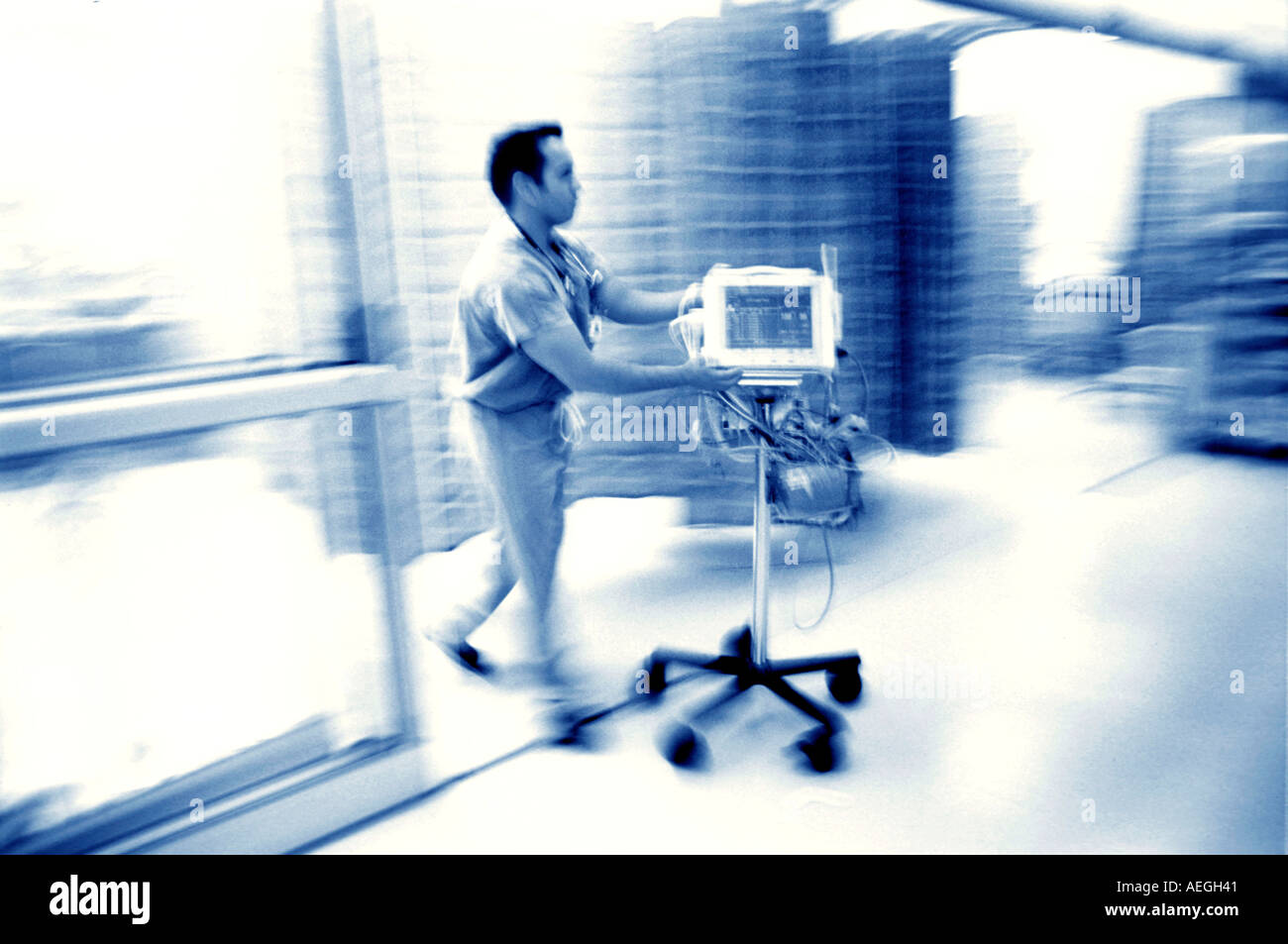 Doctor transporting heart monitor Stock Photo - Alamy