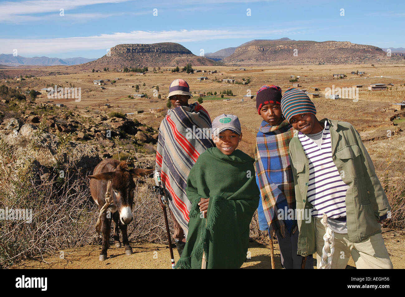 Herder boy in green cape and hat in the dry mountains of Lesotho Stock ...