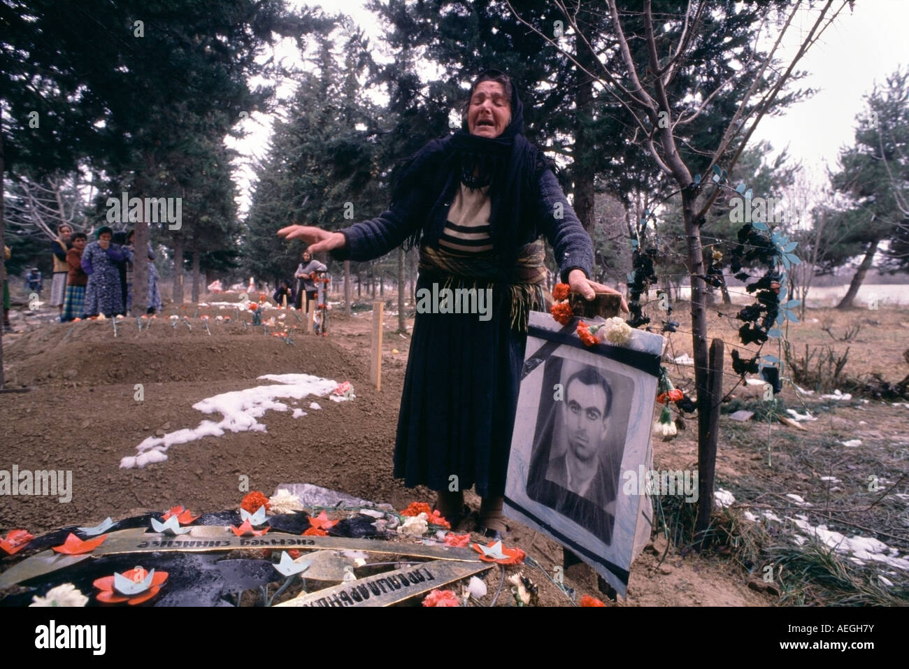 Woman cries at grave in a cemetery in Baku, Azerbaijan. Photo by Chuck ...