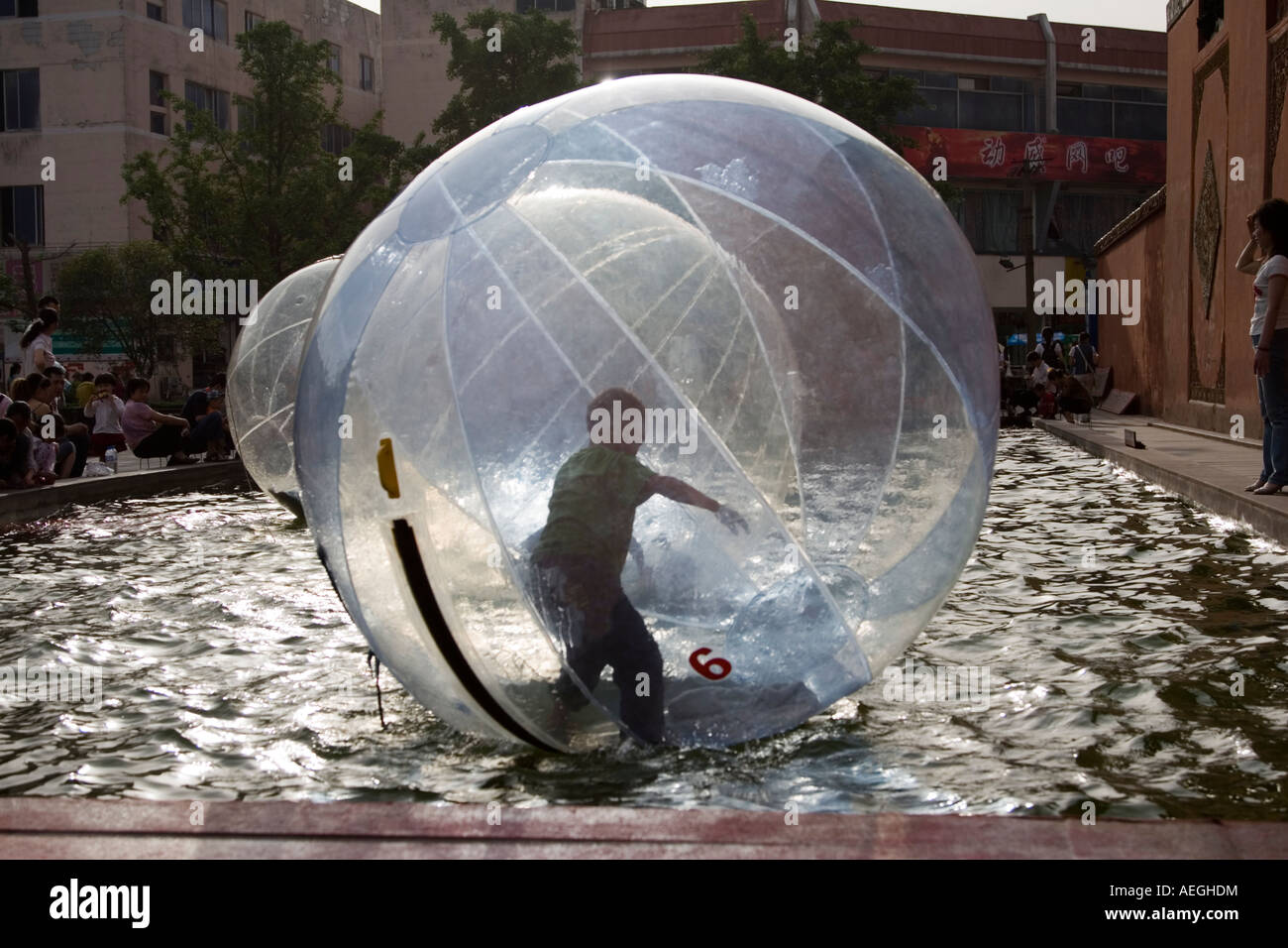 Children play in a plastic bubble or cubicle at a park in China Stock ...