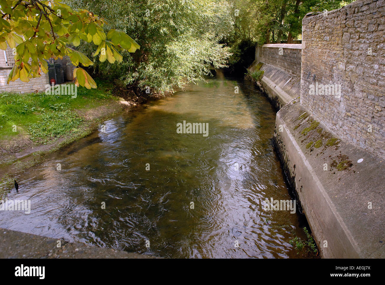 The River Thames flowing through the village of Kempsford ...