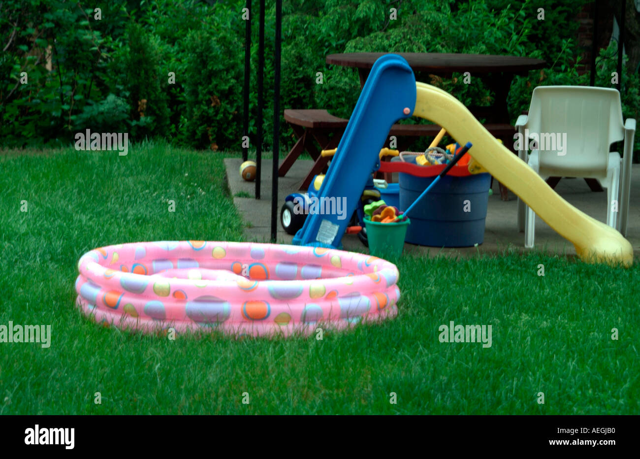 Plastic pool and toys in backyard Stock Photo - Alamy