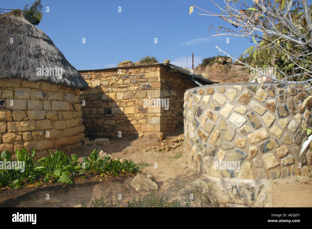 Water cistern made of stone with stone rondavel and storage building in ...