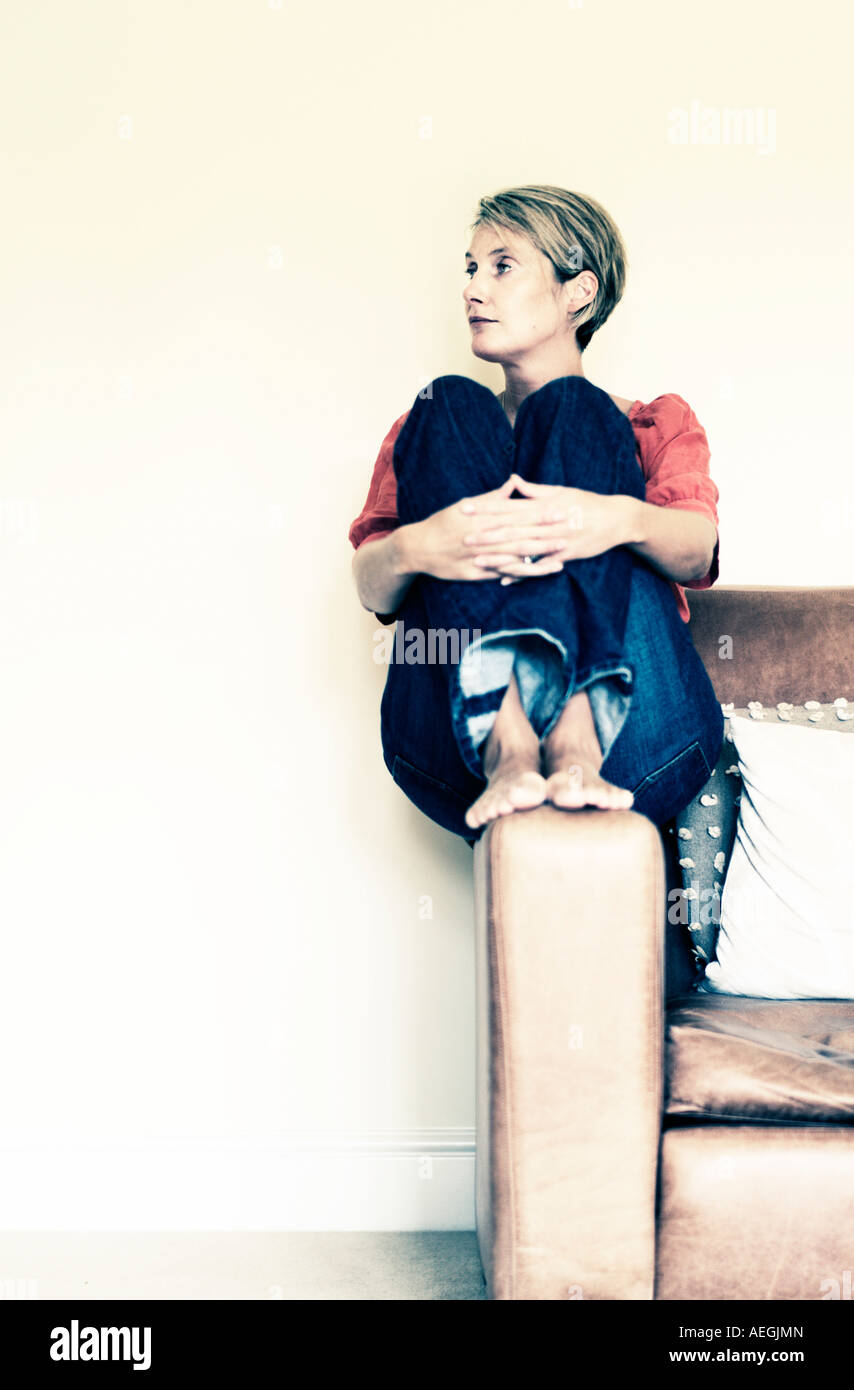 Girl perched on a chair Stock Photo - Alamy