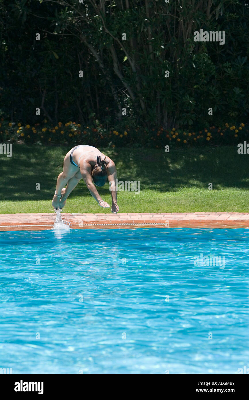 Girl diving into swimming pool Stock Photo - Alamy