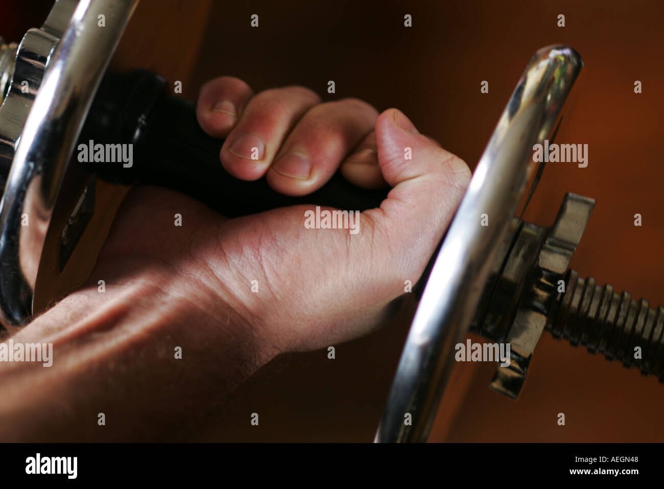 Hand lifting weight Stock Photo - Alamy