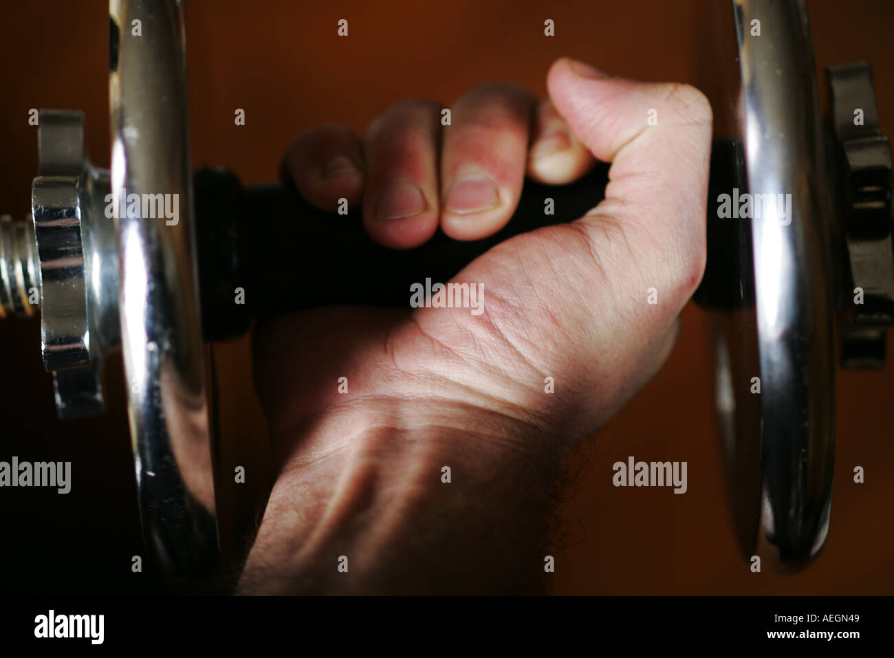 Hand lifting weight Stock Photo - Alamy