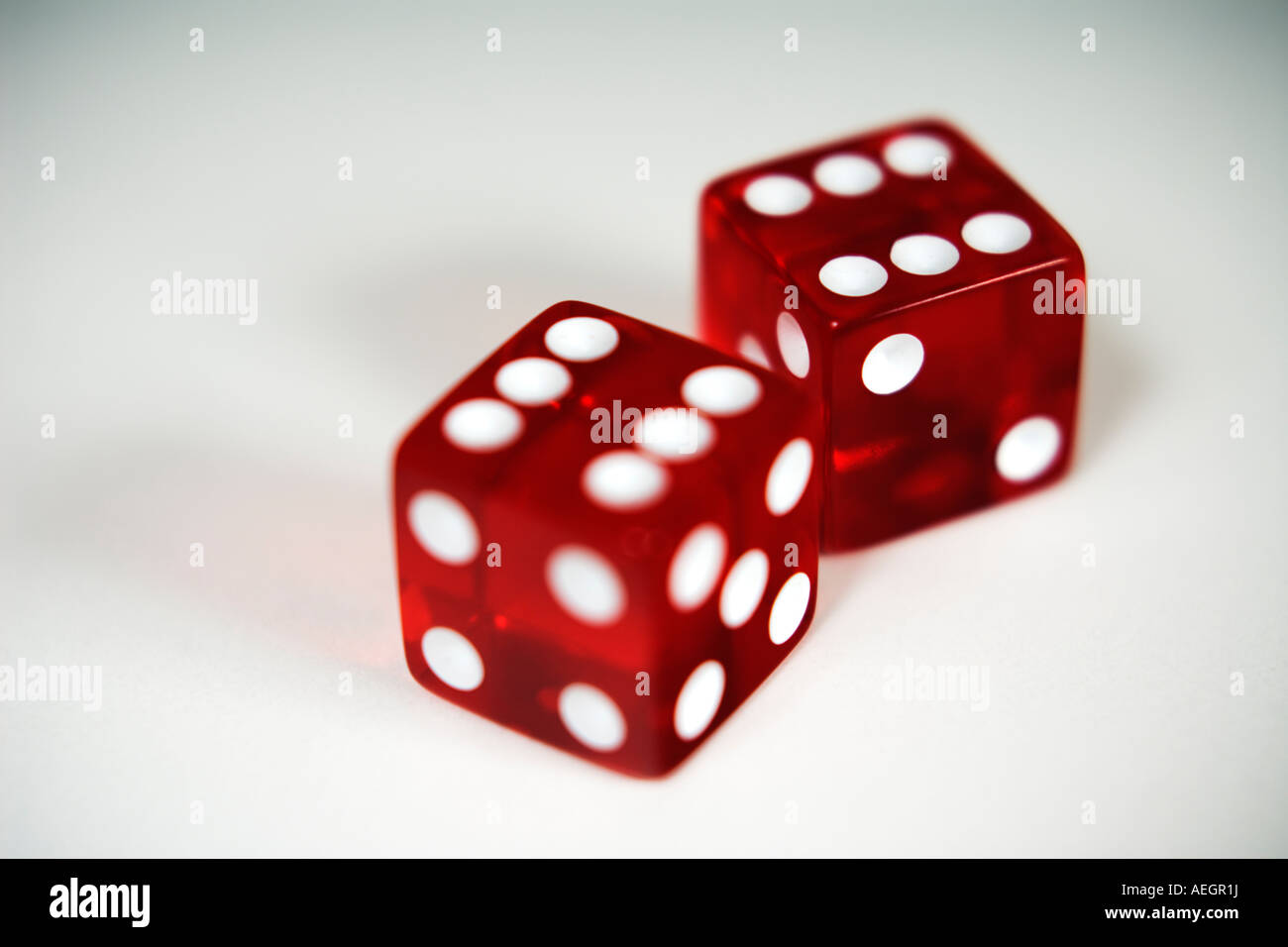 Two cherry red dice showing double six' on a white surface Stock Photo ...