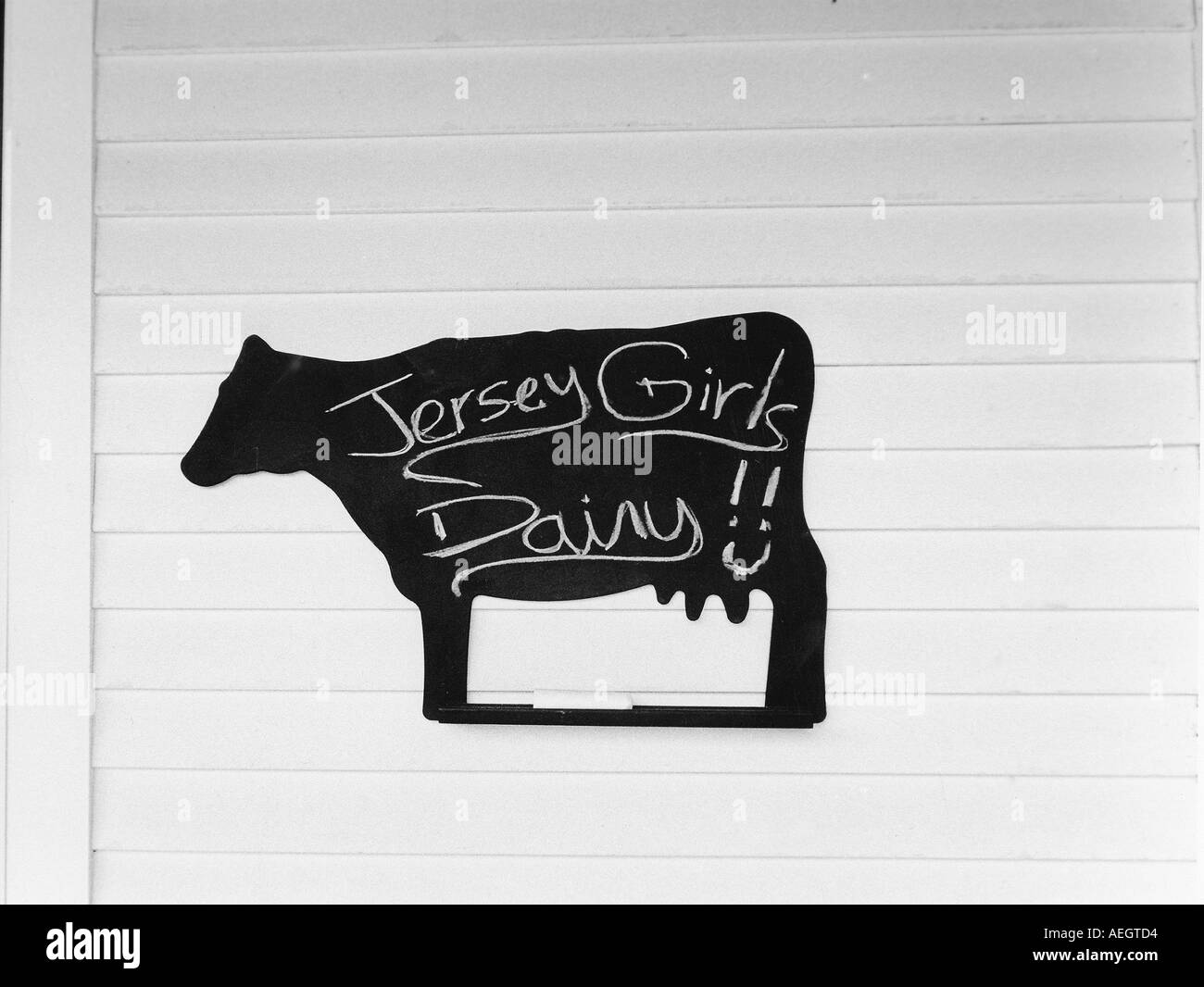 Cow shaped sign over barn Stock Photo - Alamy