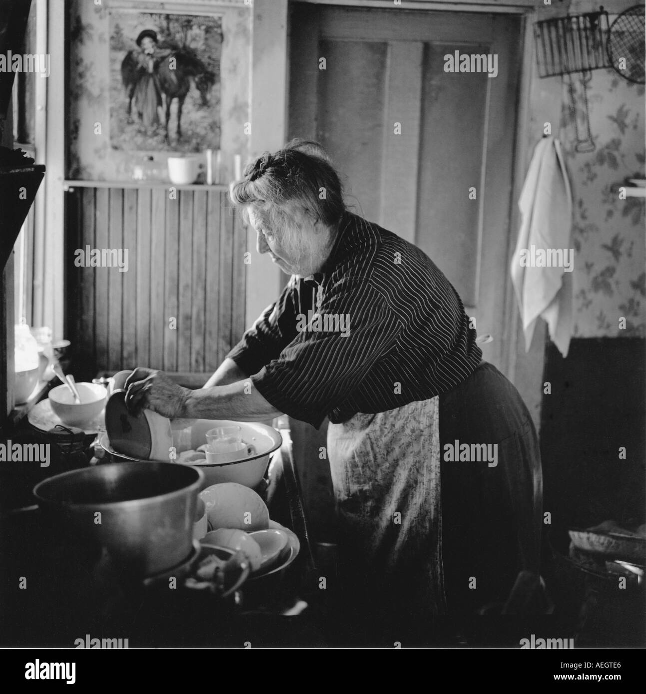 Elderly farm woman washing dishes in basin Stock Photo - Alamy