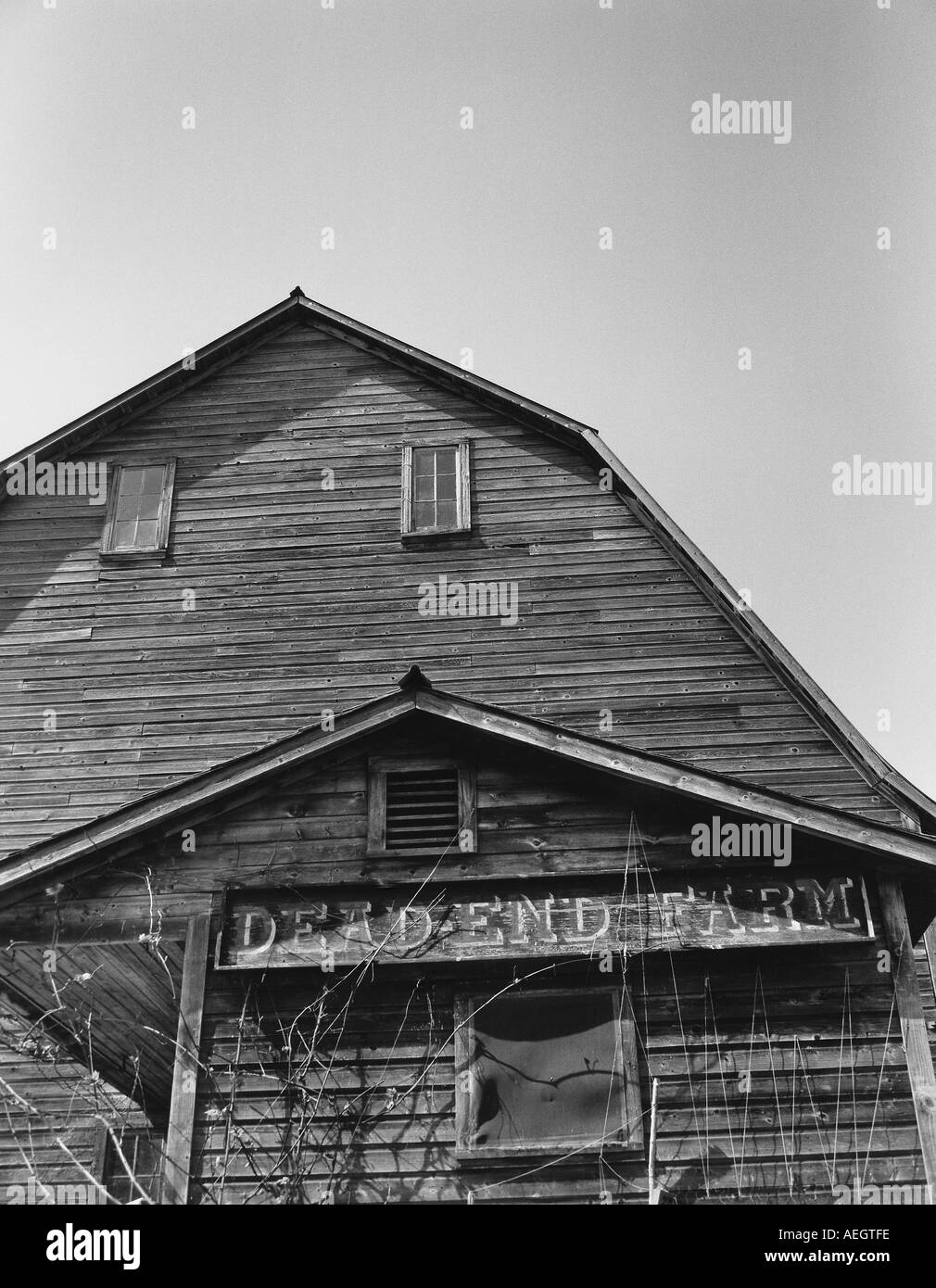 Side of a wooden barn with two windows Stock Photo - Alamy