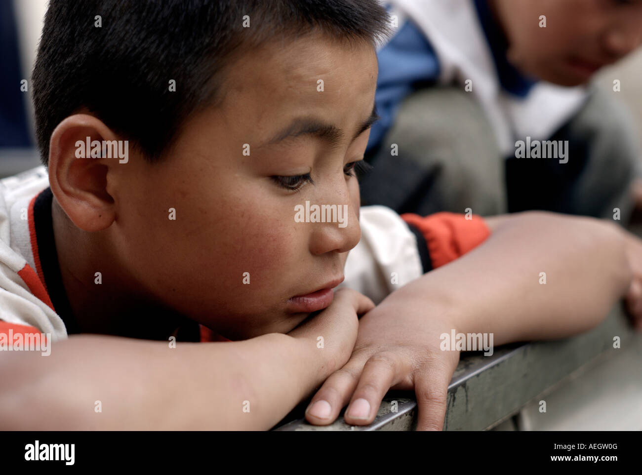 Boy watching Lhasa street life Stock Photo - Alamy