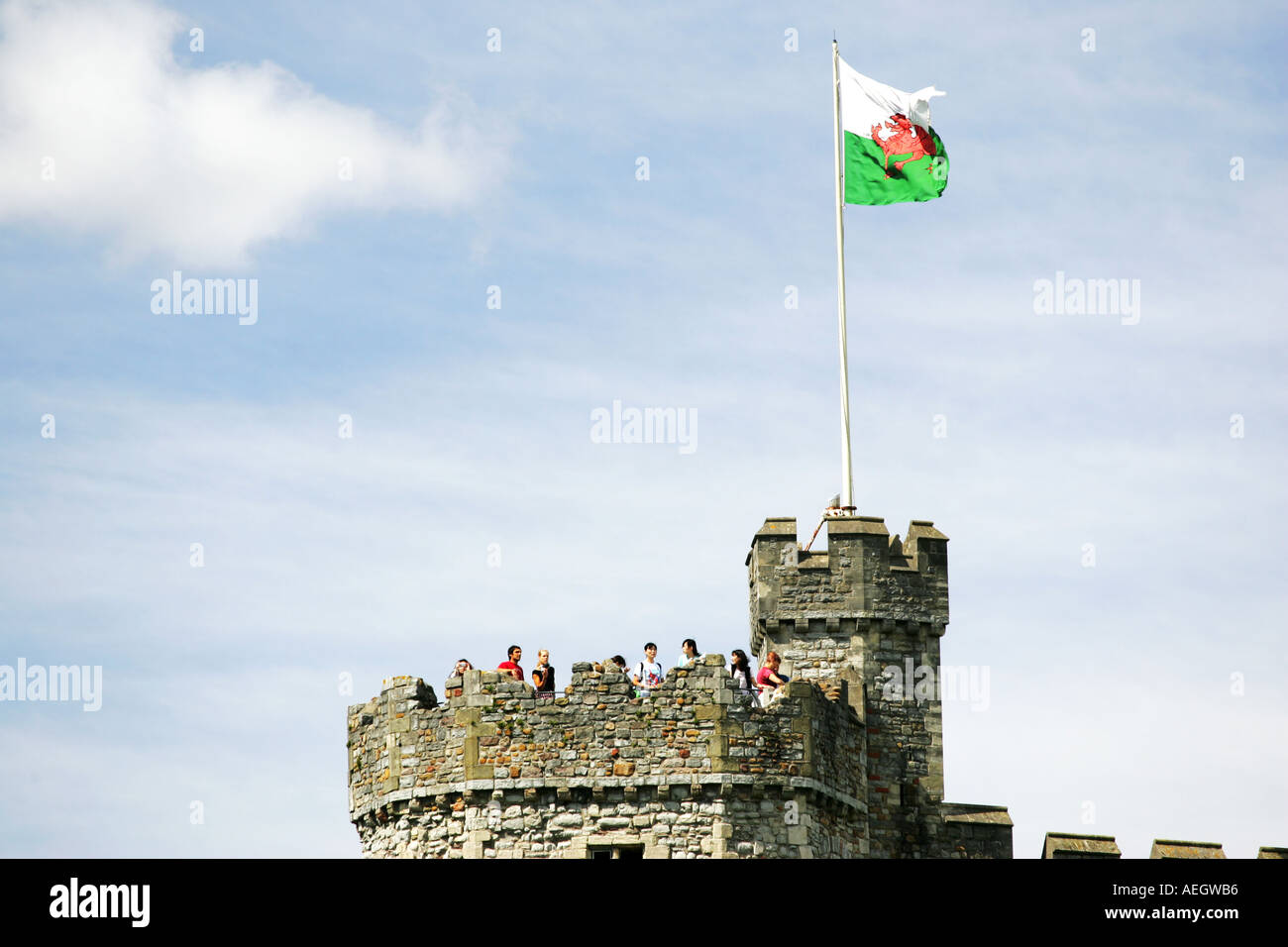 Tourists gather under the Welsh national flag flying on top of famous ...