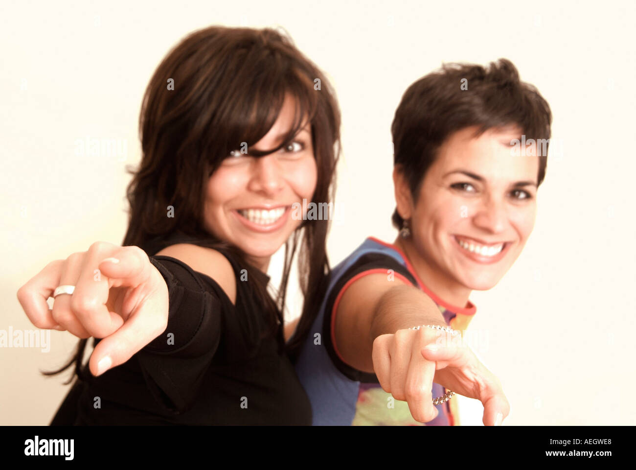 Two women pointing Stock Photo - Alamy