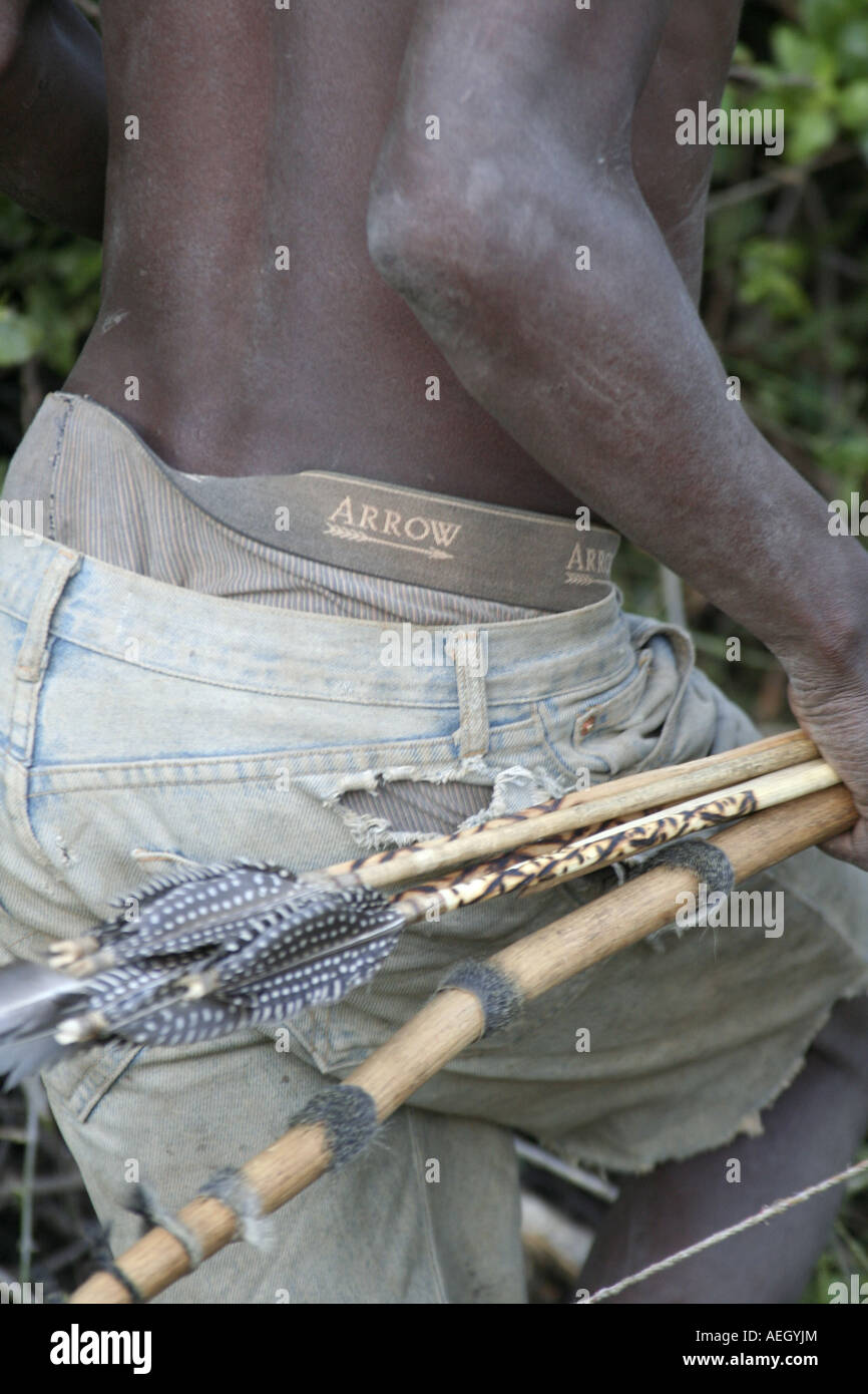 Hunter member of hunter gatherer Hadza tribe hunting with bow and arrow ...
