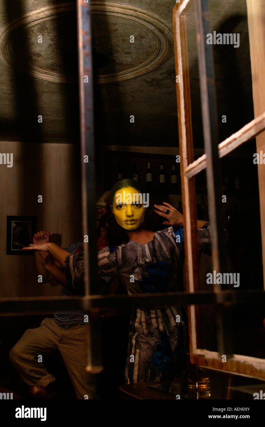 Young woman teen dancing indoors with face mask stuck on back head ...