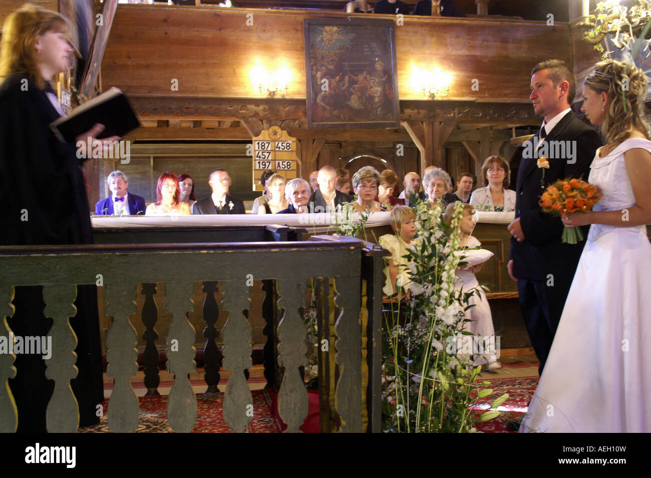 Traditional slovak wedding in ancient wooden church. Bride and groom ...
