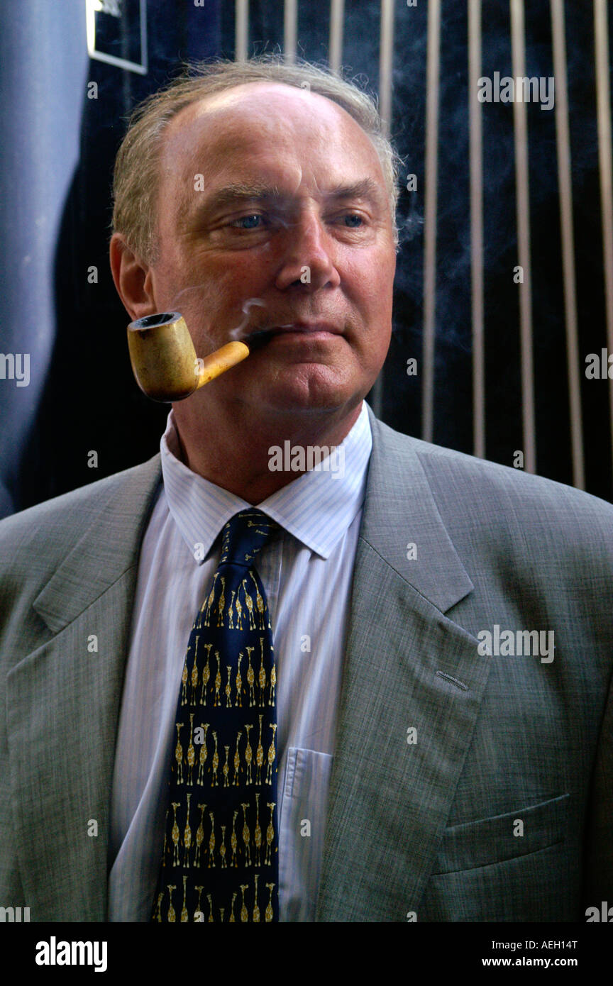 One old english man in suit and tie smoking pipe outdoors Stock Photo ...