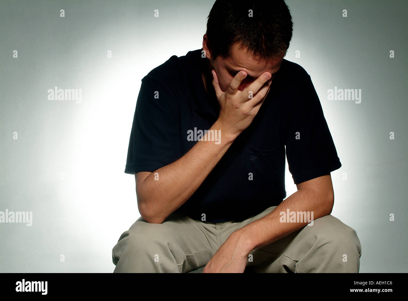 Expressions male man person young sitting worried worry hand face ...