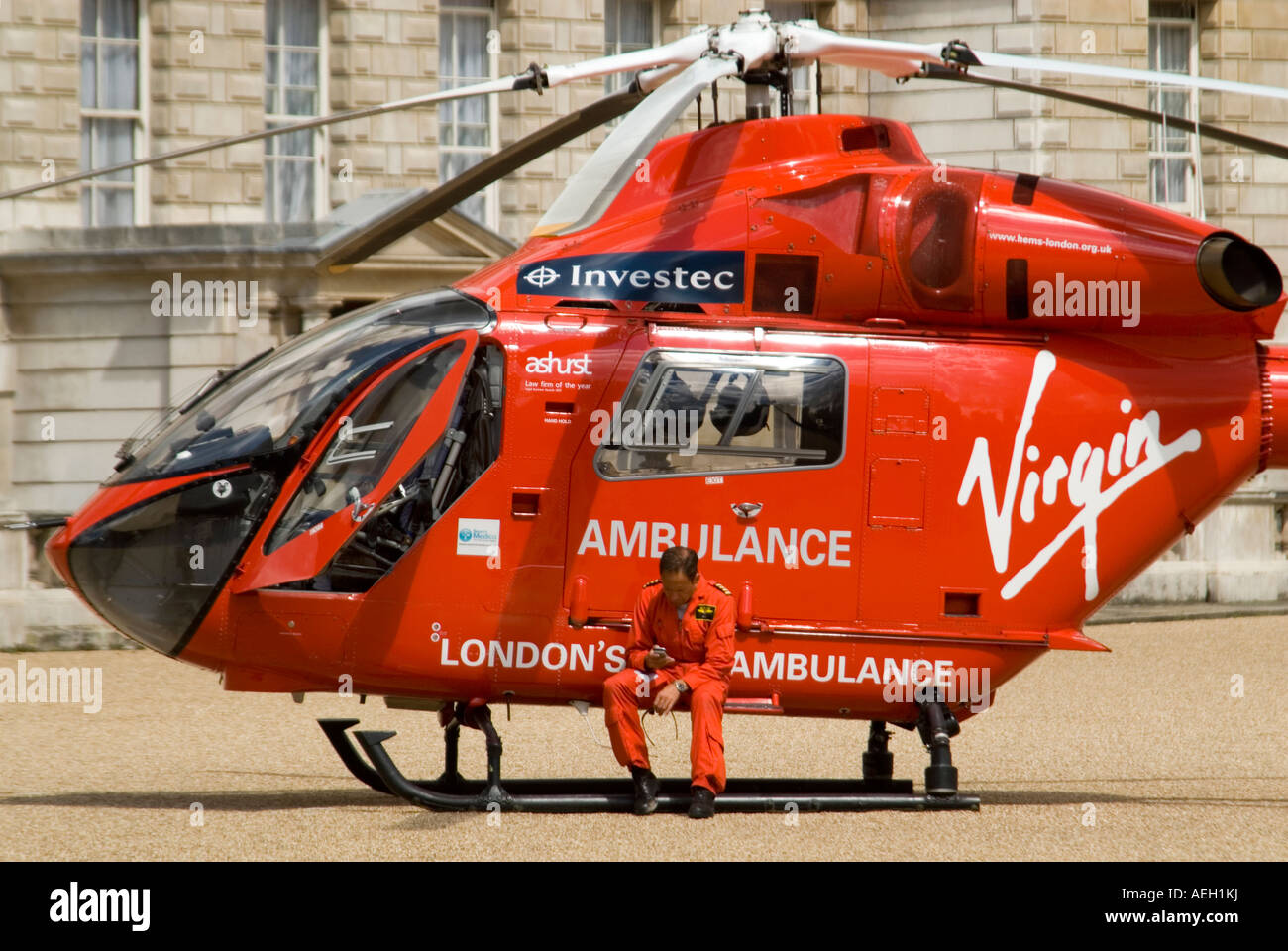 Horizontal close up of London's Air Ambulance with the pilot texting on ...