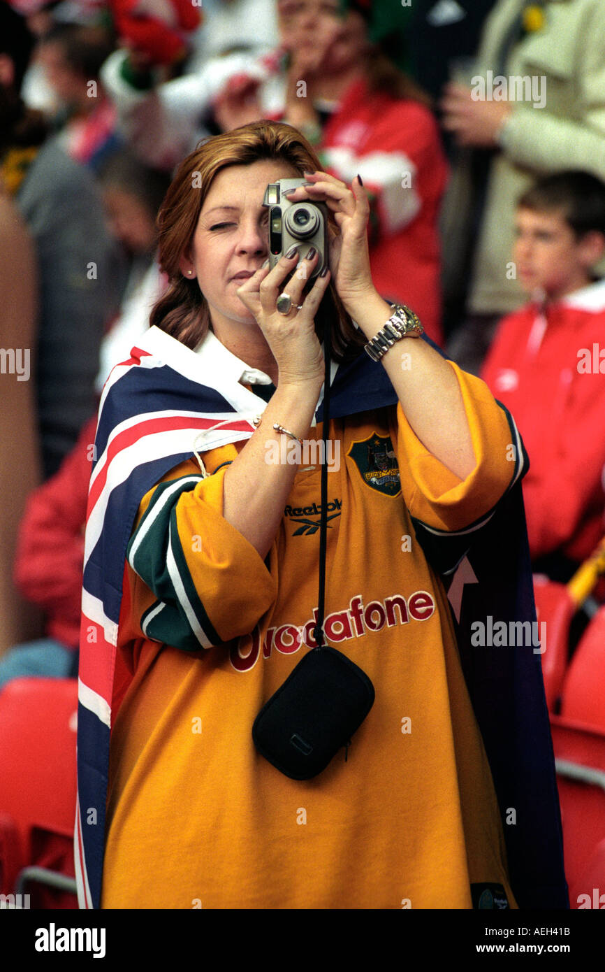 Female Australia rugby fan draped Australian flag taking a photographs ...