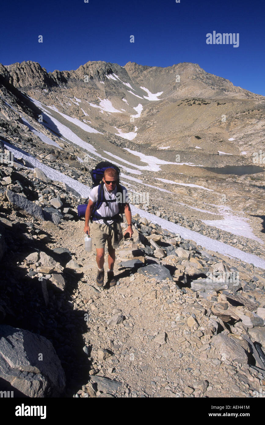 Hiker climbing Glenn Pass near Rae Lakes in Kings Canyon National Park ...
