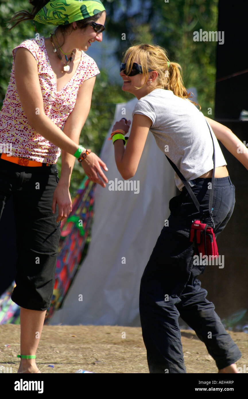 Two girls teen woman dancing happy outdoors at rave party in Slovakia ...