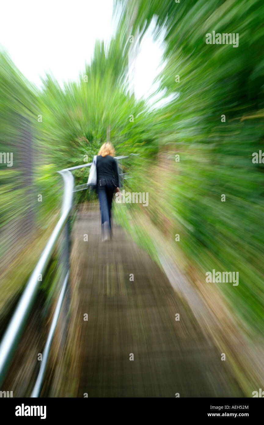Lone woman walking on staircase outdoors, zoom blur Stock Photo - Alamy
