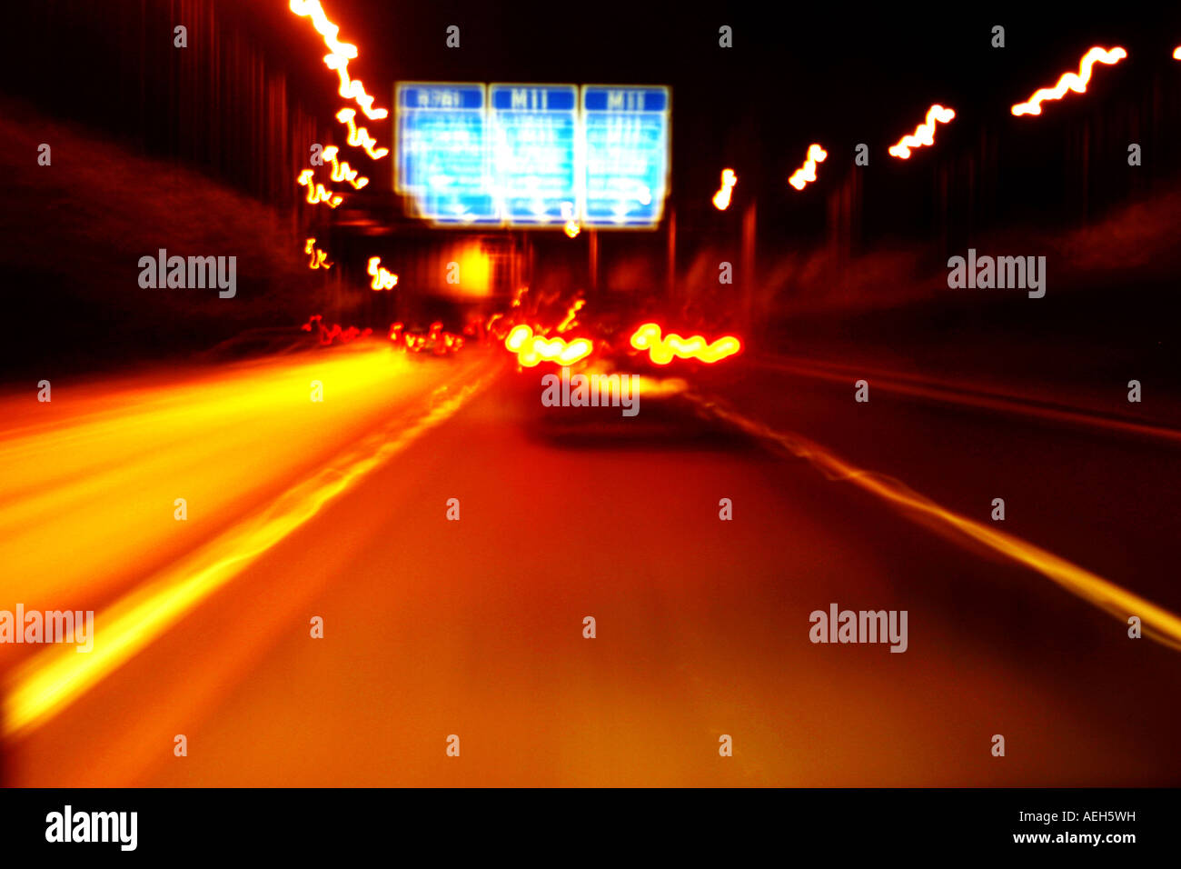Driving car fast on motorway being a speed demon at night Stock Photo ...