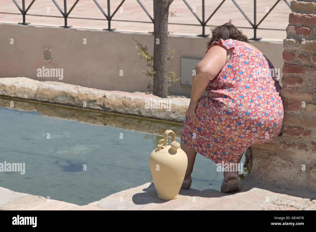 Andalusia Spain Woman filling botijos or earthenware jug Stock Photo ...