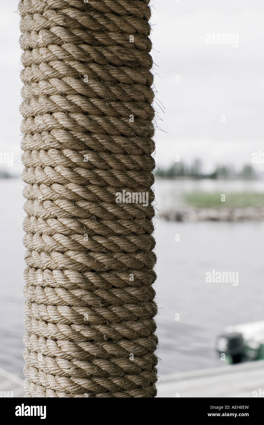 Rope tightly bound around a vertical and rectangular wooden beam used ...