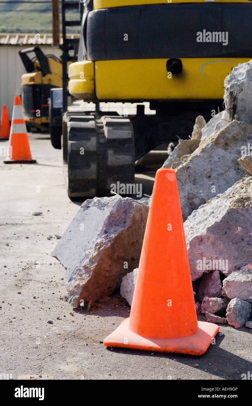 Construction site. Blocks of concrete with an orange cone in foreground ...