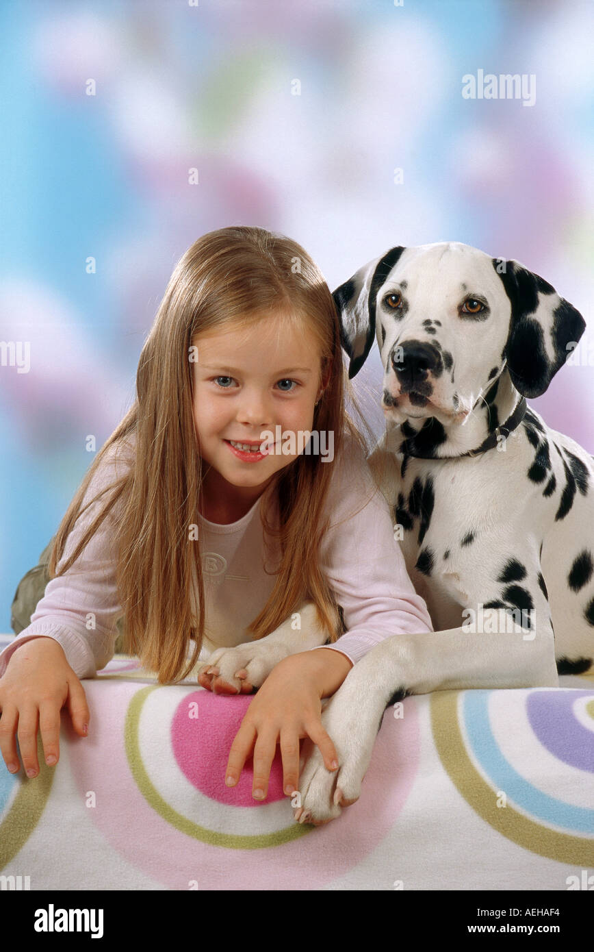 girl lying next to dalmatian dog Stock Photo - Alamy