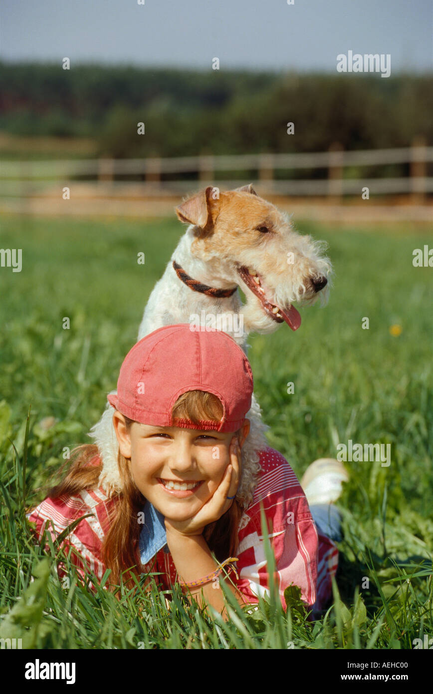 fox terrier dog and girl on meadow Stock Photo - Alamy
